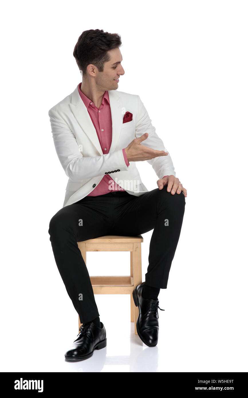 positive modern seated man agrees with someone next to him on white ...