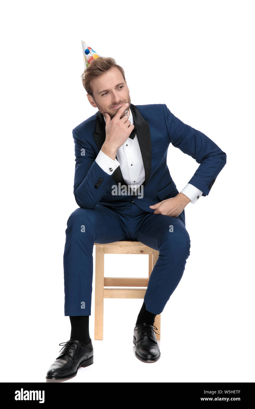 seated elegant man in blue suit thinking, wondering and celebrating ...