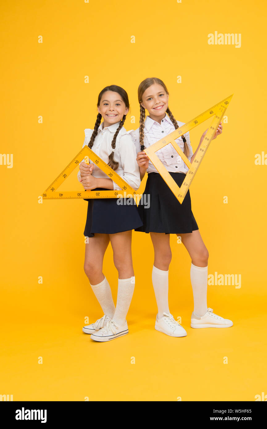 School students study geometry. Pupil school girls big rulers. School ...