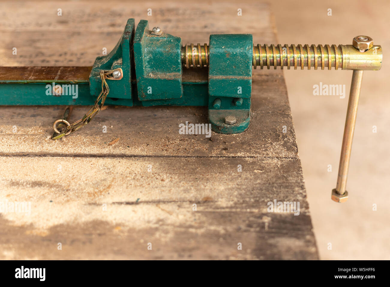 Workpiece clamp, Metal table vise clamp on the wood table. Copy space ...