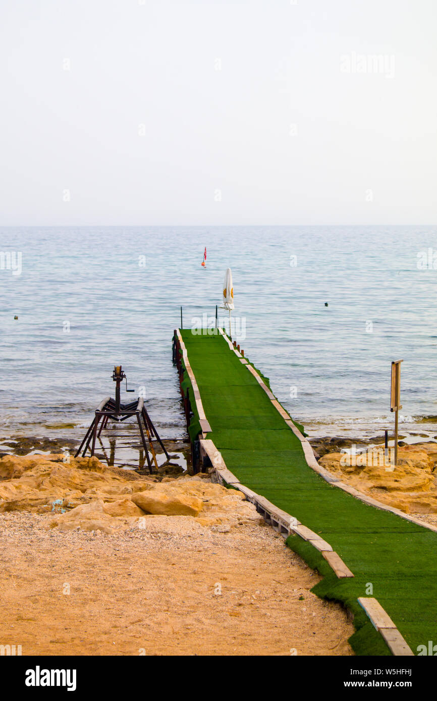 Plank footpath extending over calm water Stock Photo - Alamy