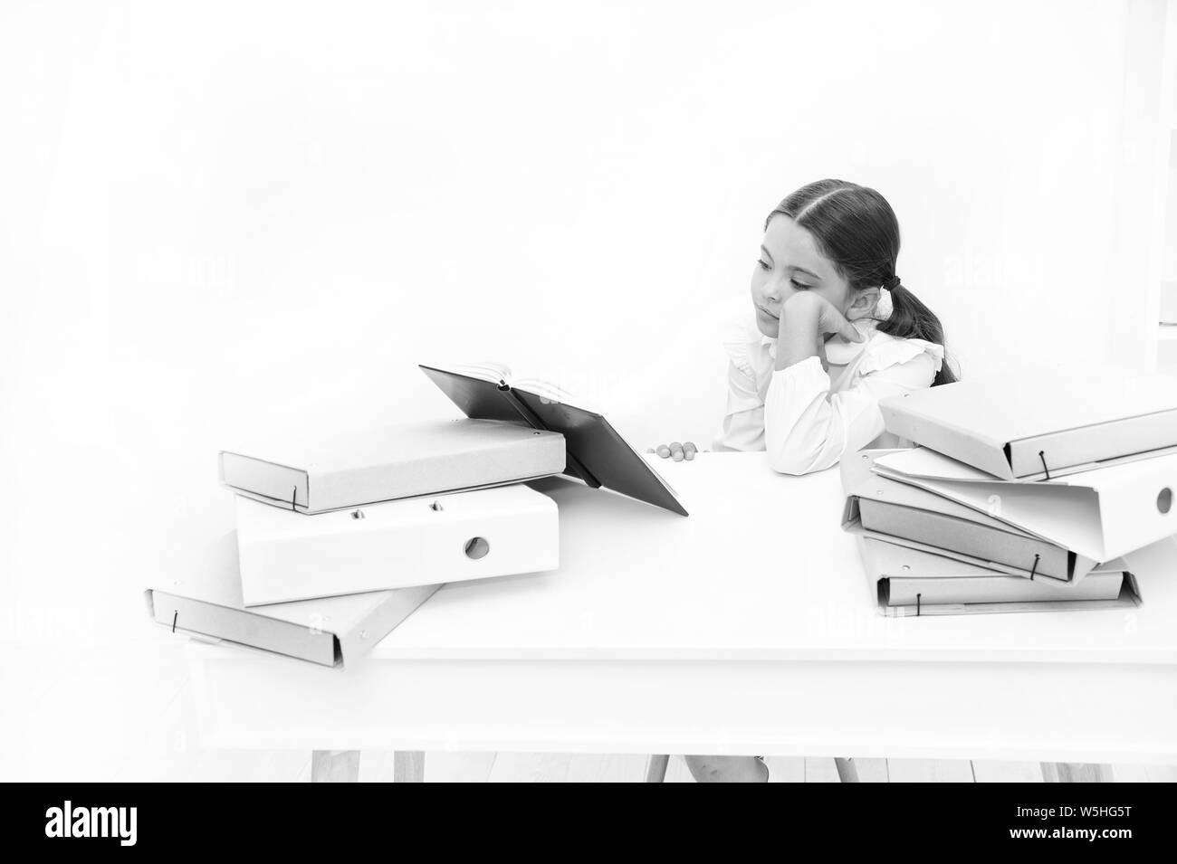 Reading makes her feel bored. Adorable pupil develop reading skills ...