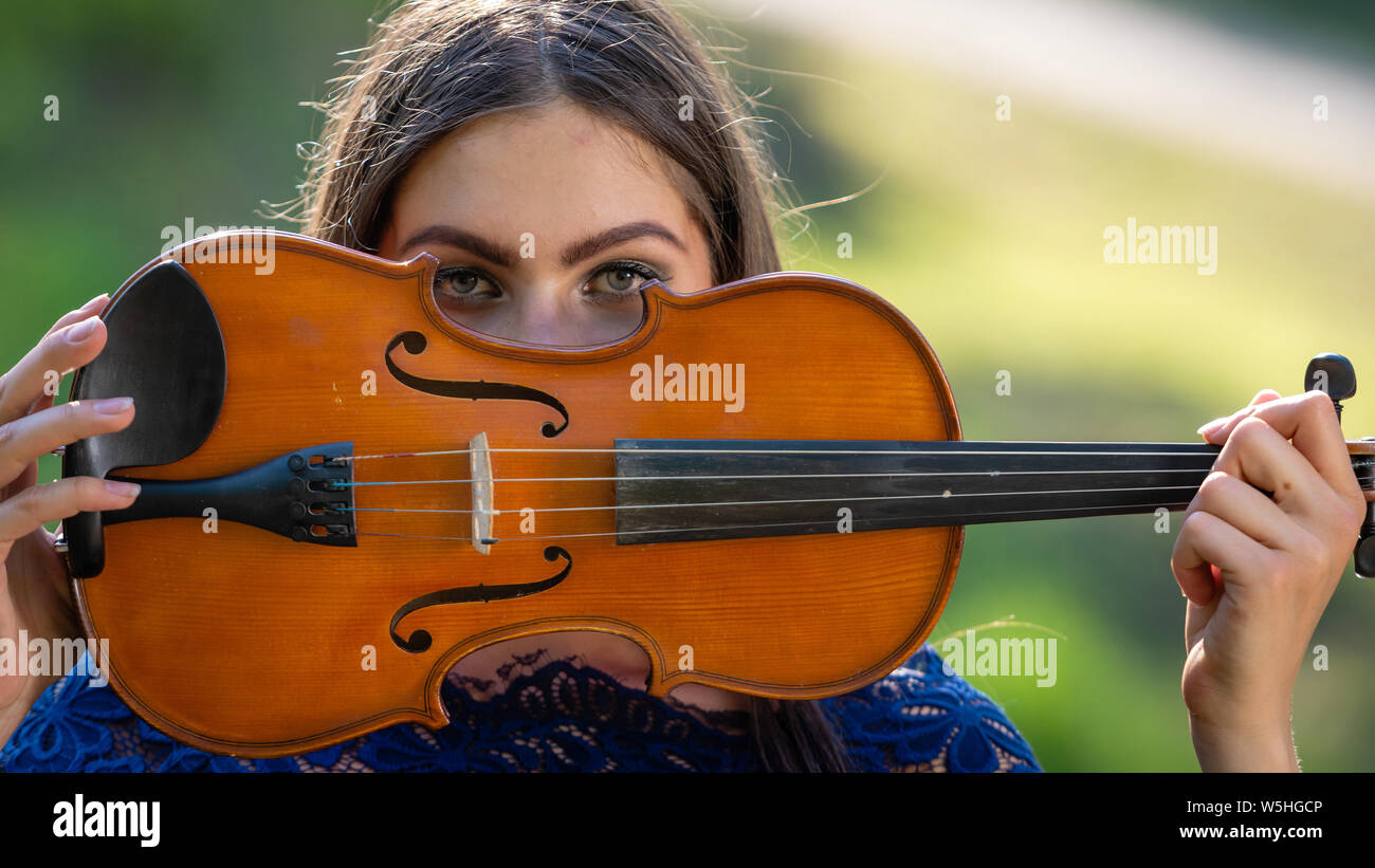 Portrait of a positive young woman. Part of the face is covered by the ...