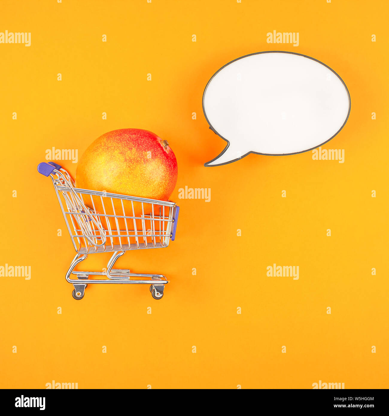 Mango fruit in shopping cart in creative conceptual top view flat lay ...