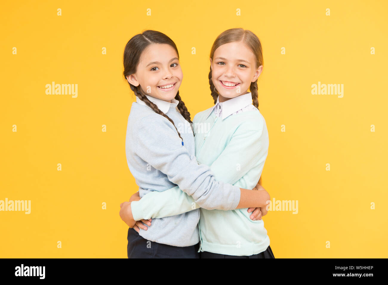 best friends. smart little girls on yellow background. education ...