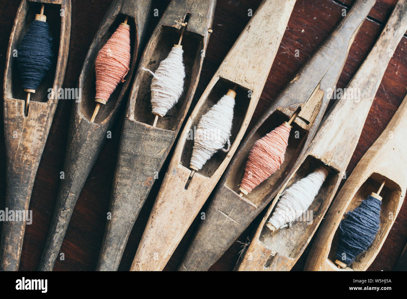 Vintage filling carriers of the loom with spool of colorful threads ...