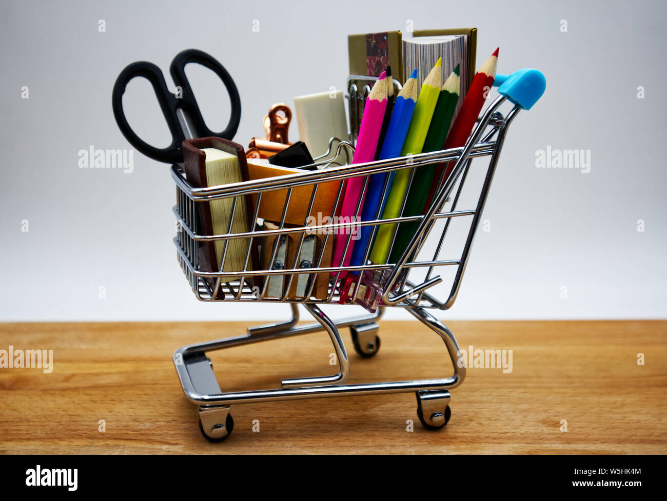 Different school supplies in a supermarket trolley. Back to school ...