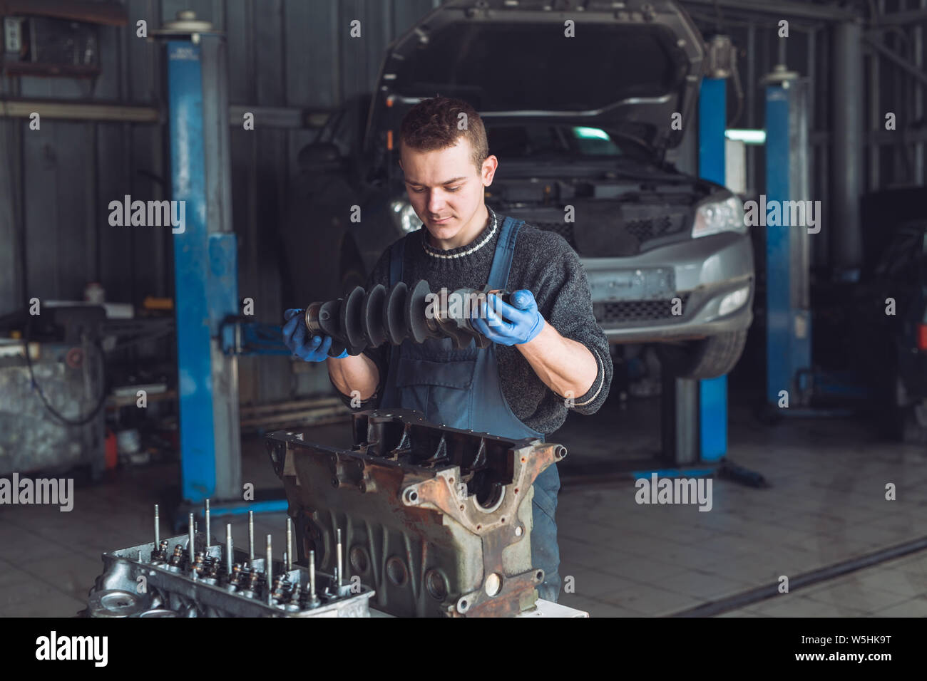 Master collects a rebuilt motor for the car Stock Photo - Alamy