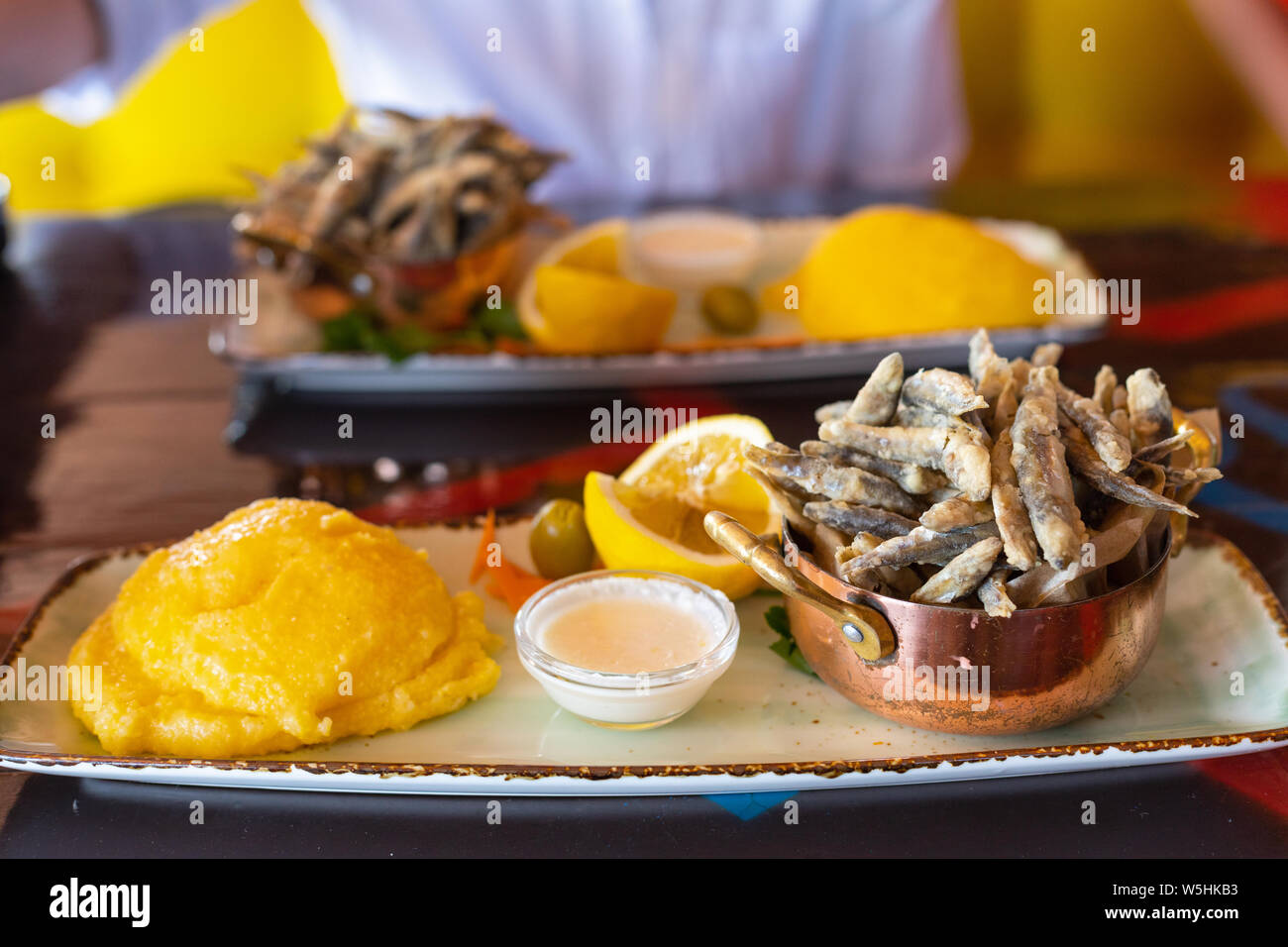 Friend anchovy fish (hamsi) with lemon, garlic sauce and creamy samp ...