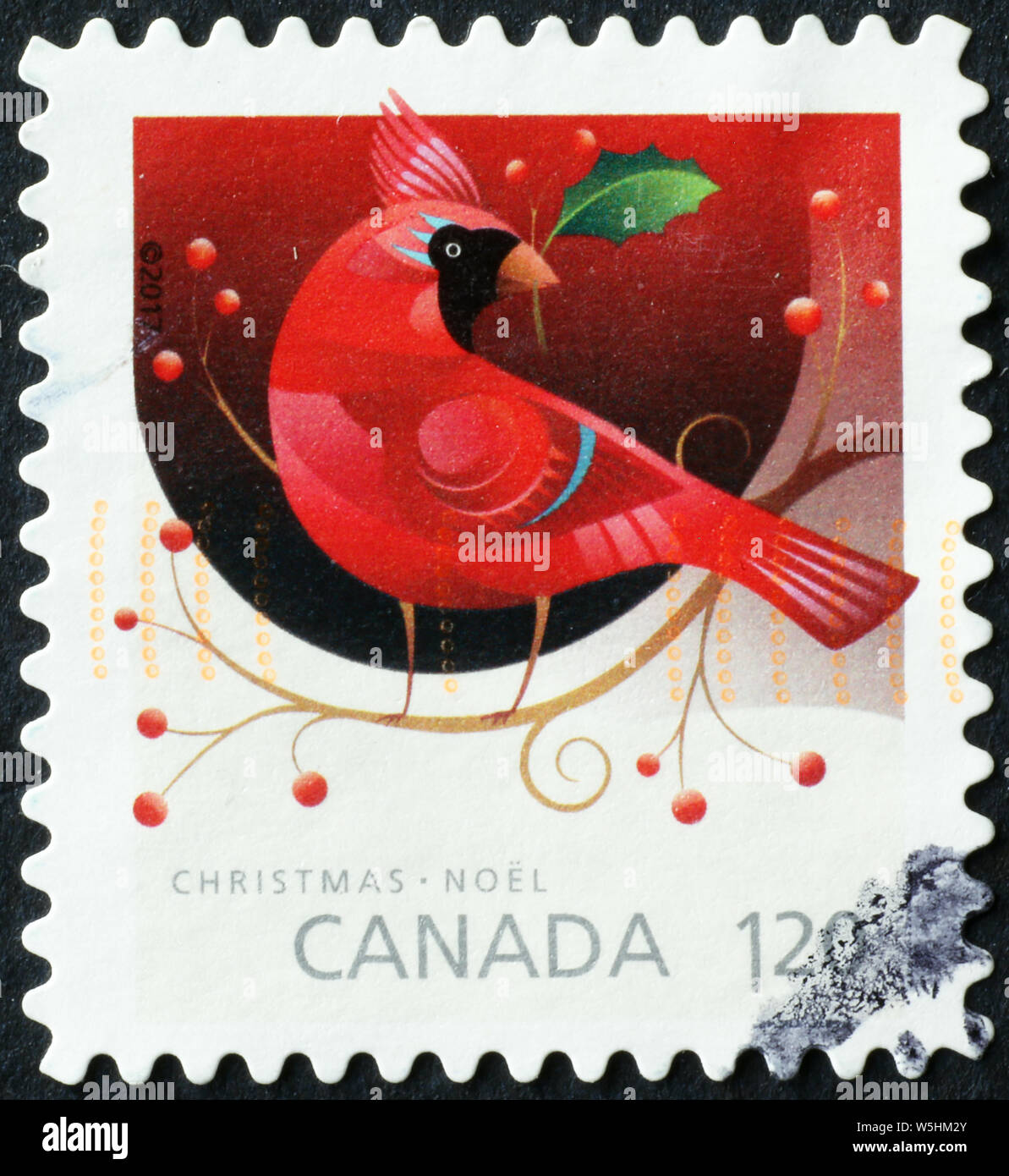 Stylized red cardinal bird on Christmas canadian stamp Stock Photo - Alamy