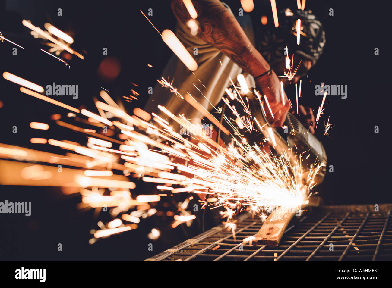 Worker Using Angle Grinder in Factory and throwing sparks Stock Photo ...