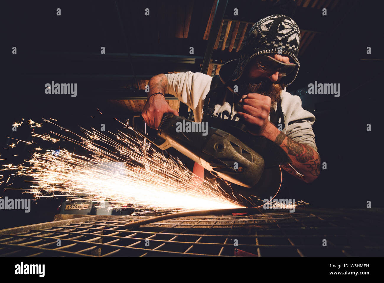 Worker Using Angle Grinder in Factory and throwing sparks Stock Photo ...