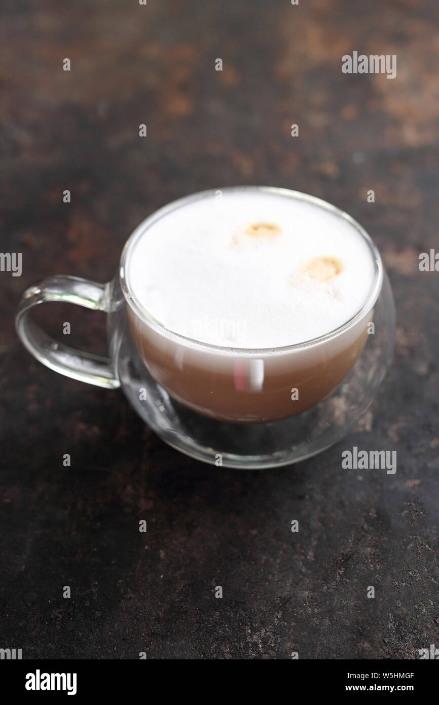 Hot, aromatic coffee with milk. Drink on a dark background Stock Photo ...