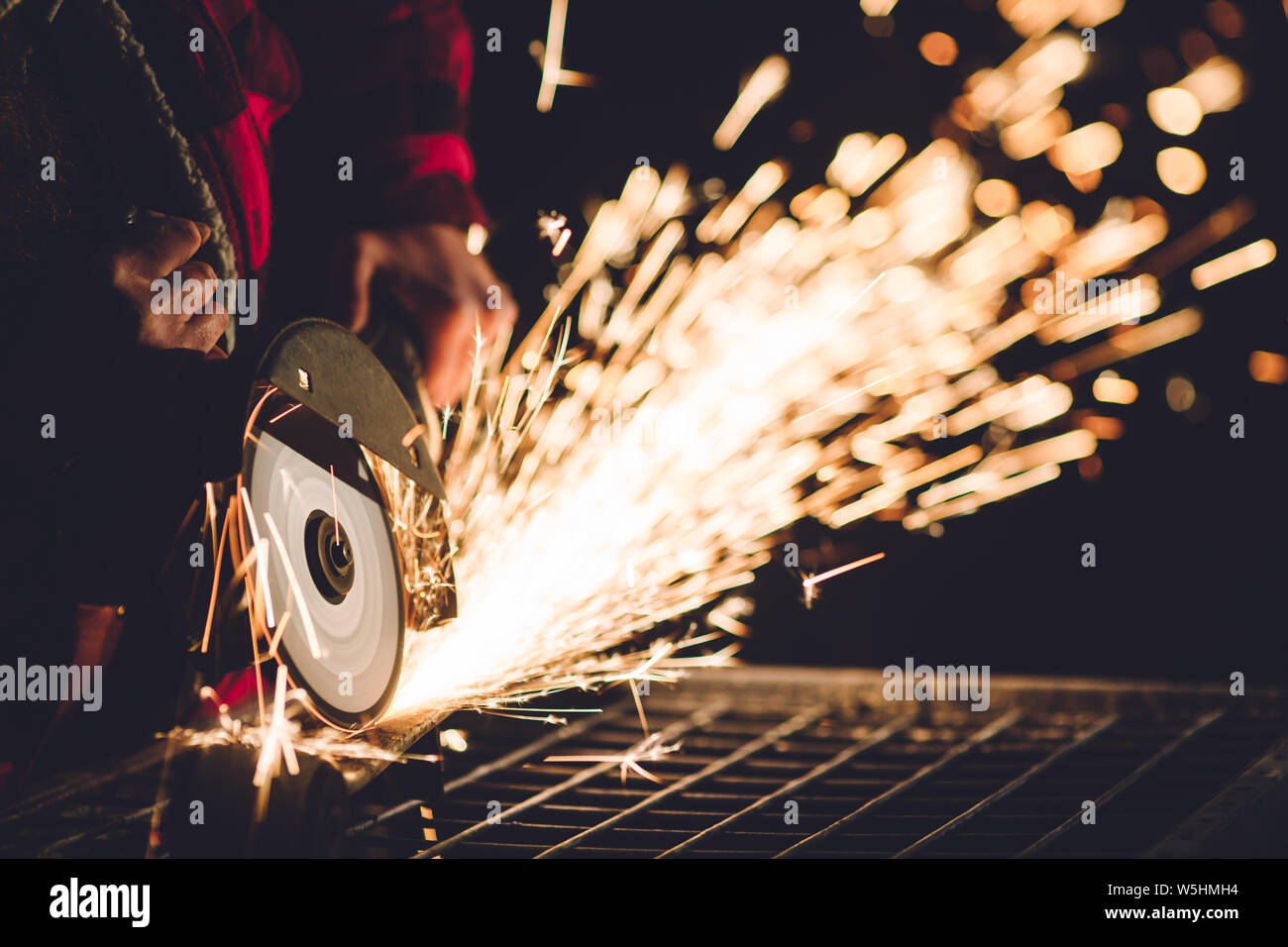 Worker Using Angle Grinder in Factory and throwing sparks Stock Photo ...