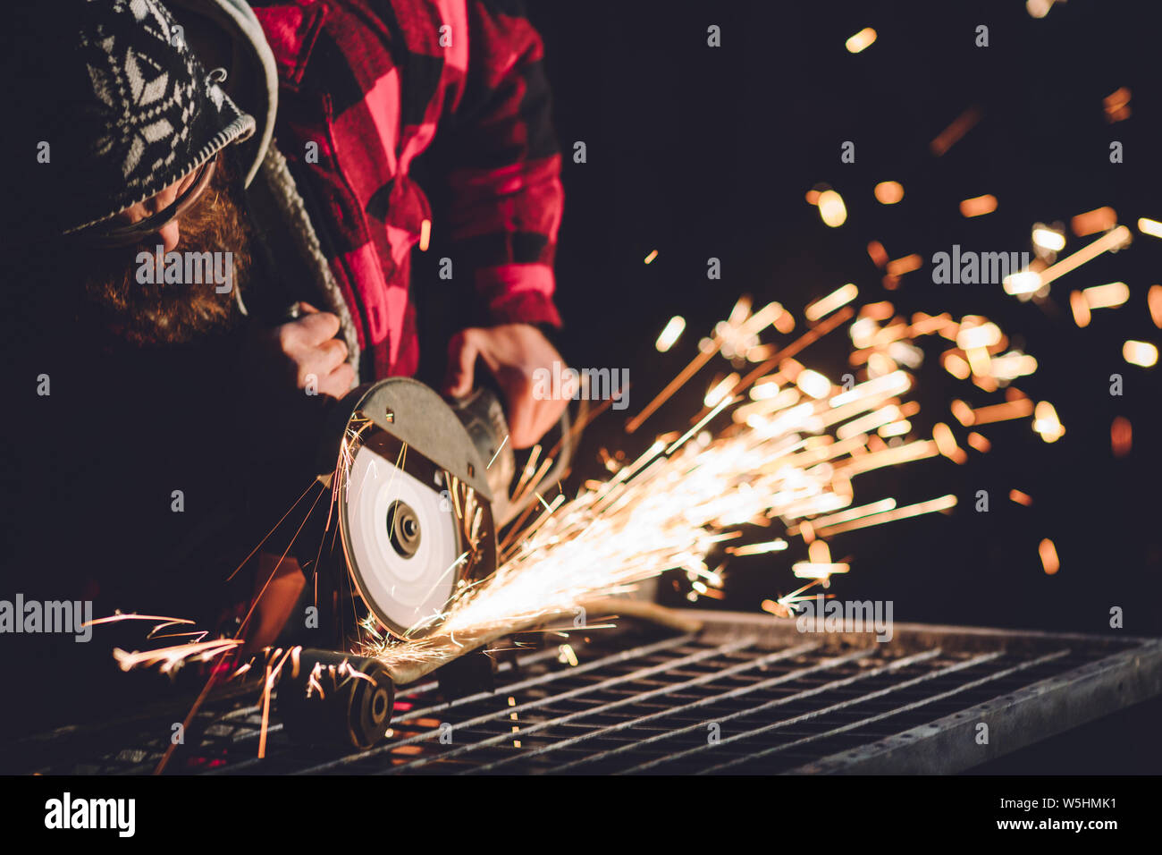 Worker Using Angle Grinder in Factory and throwing sparks Stock Photo ...