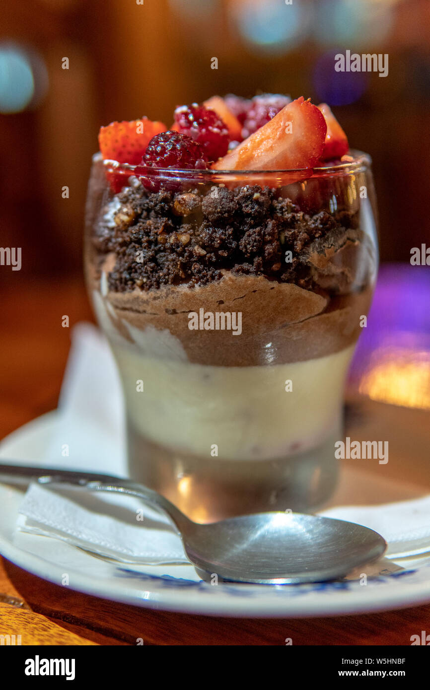 Chocolate and vanila strawberry pudding dessert with spoon in cup Stock ...