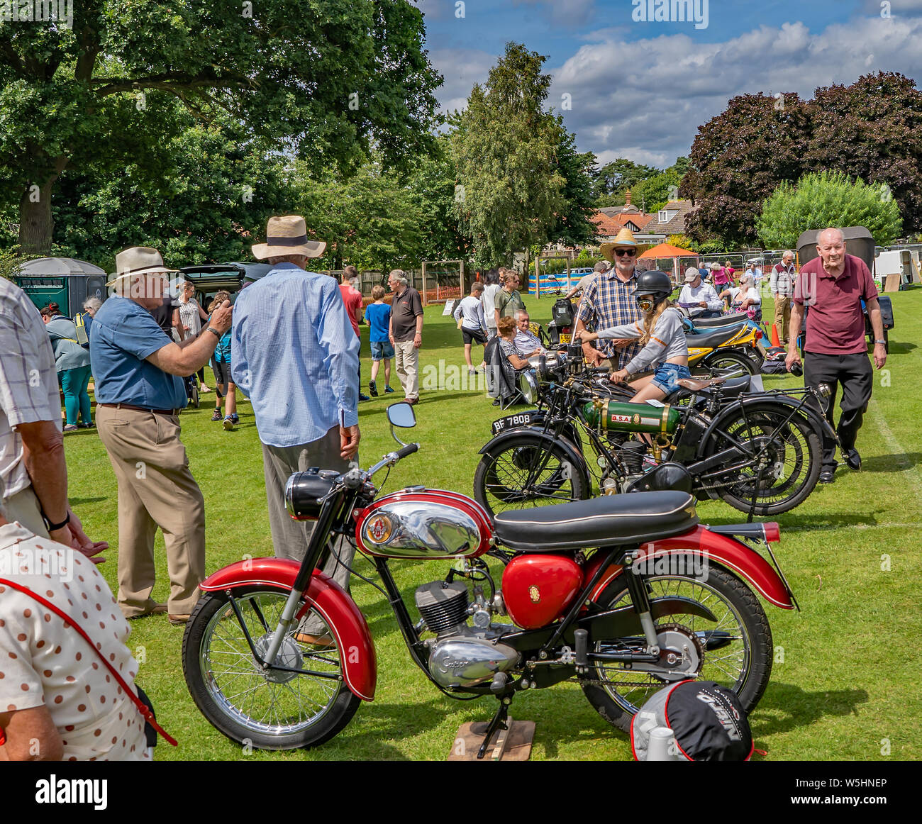 Classic car show goers looking around the collection of classic and ...