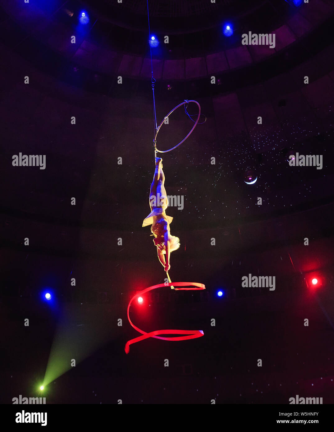 Aerial acrobat in the ring. A young girl performs the acrobatic ...