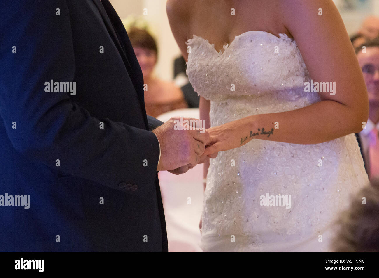 Bride and grooms hands on their wedding day, close up of Bride and ...