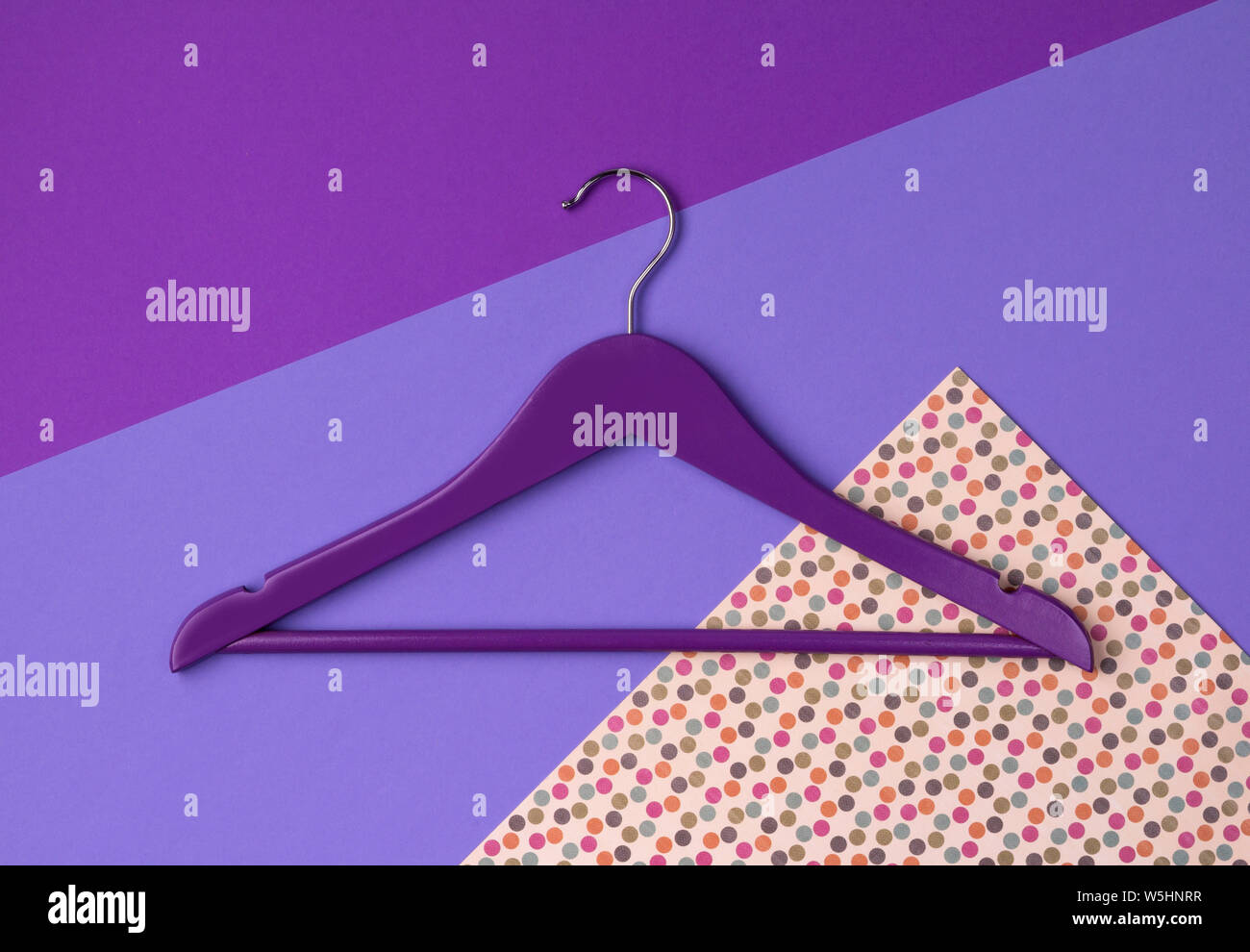 Top view flat lay single wooden hanger purple trendy background ...