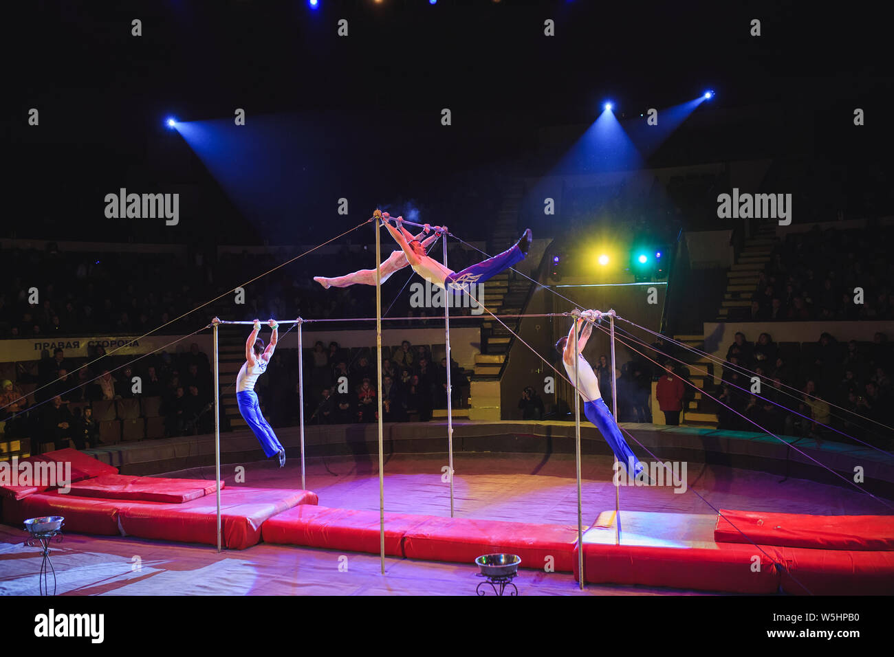 Acrobats perform exercises on the bar in the Circus arena Stock Photo ...