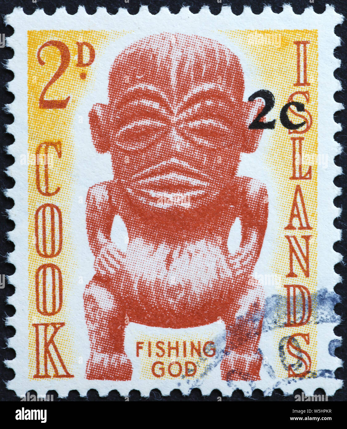 Statue of Fishing God on stamp of Cook islands Stock Photo - Alamy