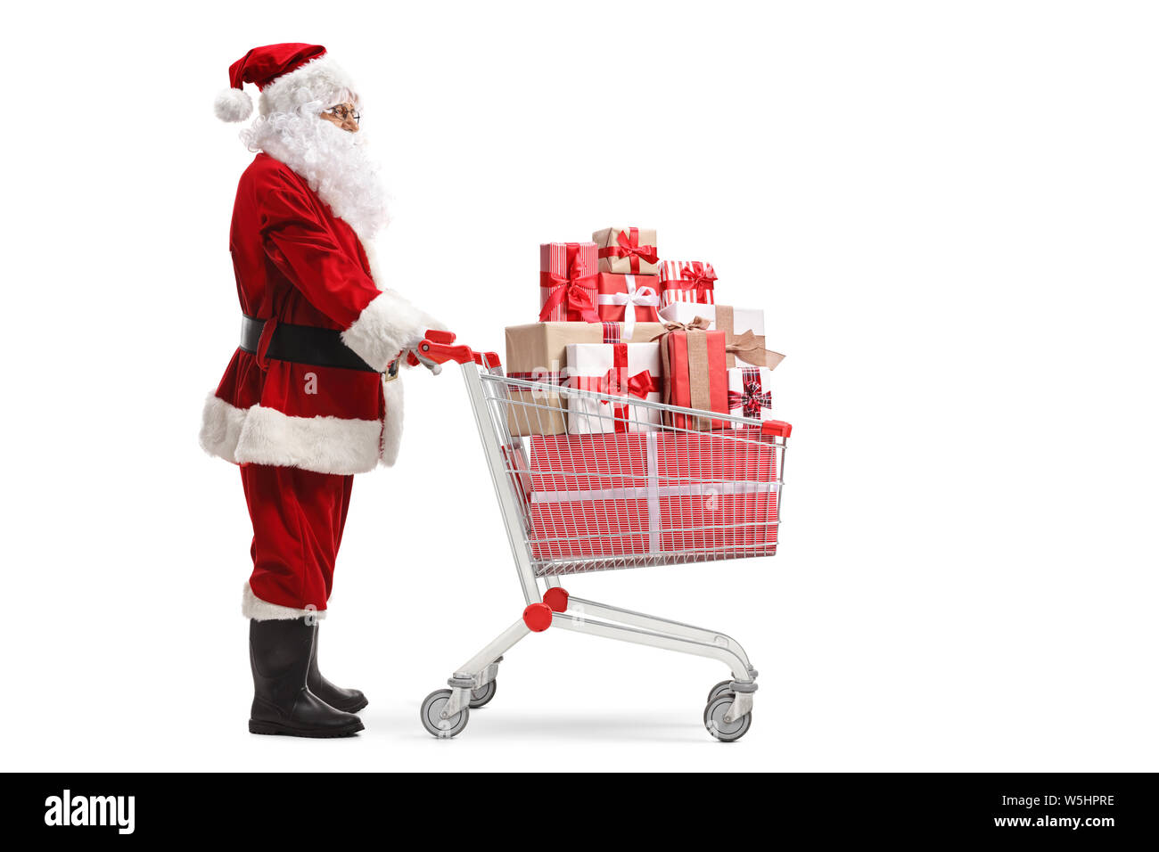 Full length profile shot of Santa Claus carrying presents in a shopping ...