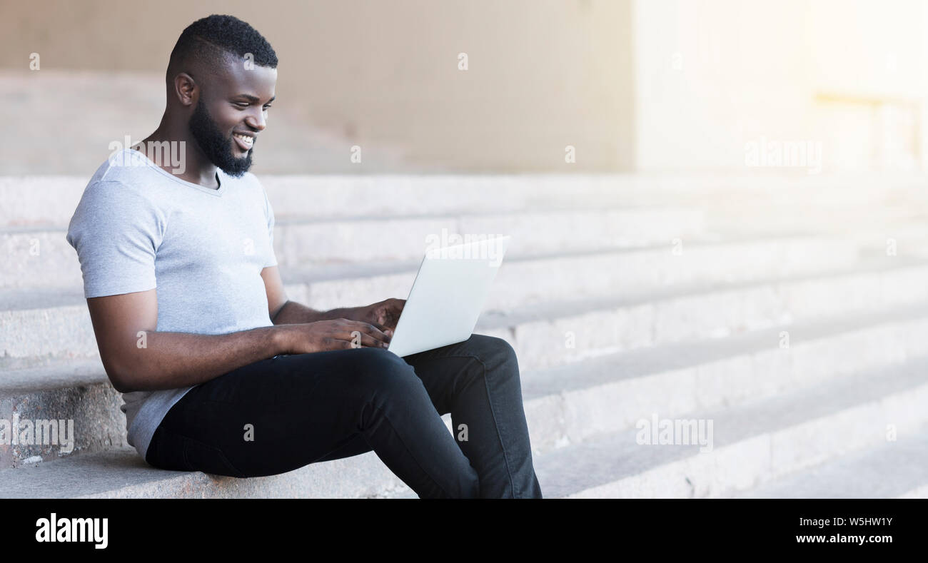 African american student doing homework between classes Stock Photo - Alamy