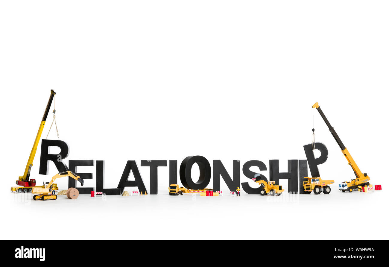 Developing a relationship: Machines building word Stock Photo - Alamy