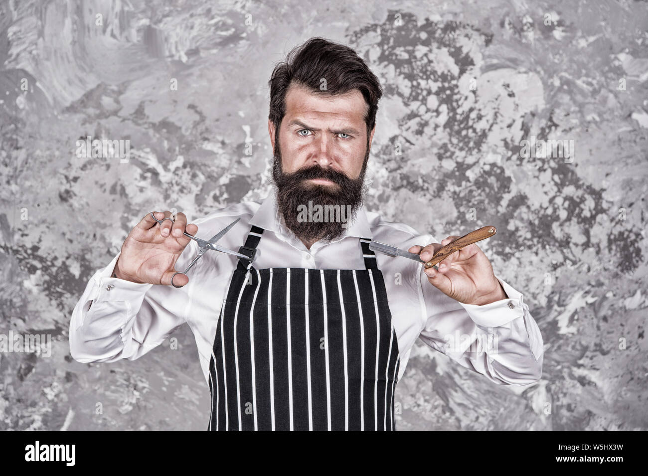 Facial hair. Bearded barber shaving. Barber tools. Barber in apron ...
