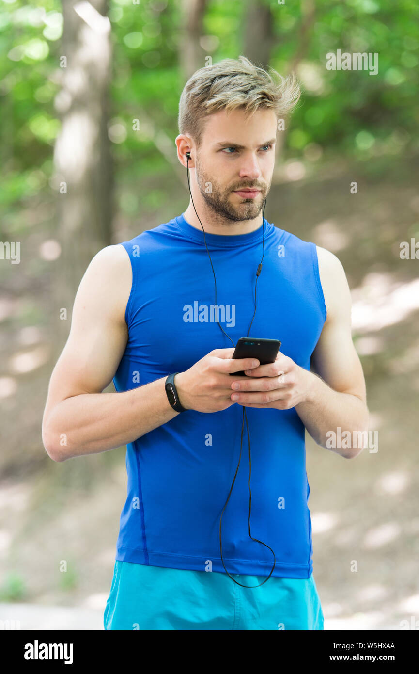 Set up route for run using application. Man smartphone ready to start ...