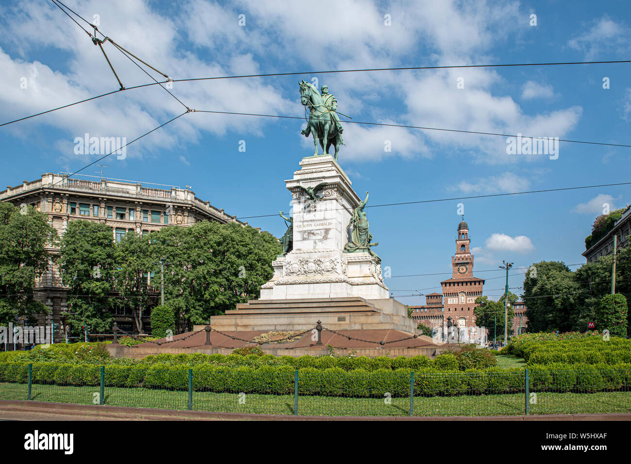 Milan, Italy; July 2019: Giuseppe Garibaldi Monument and the bell tower ...