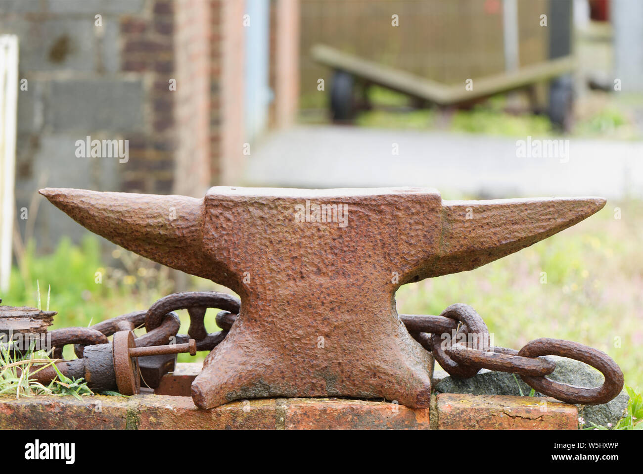 Rusty old blacksmith anvil with out of focus background Stock Photo - Alamy