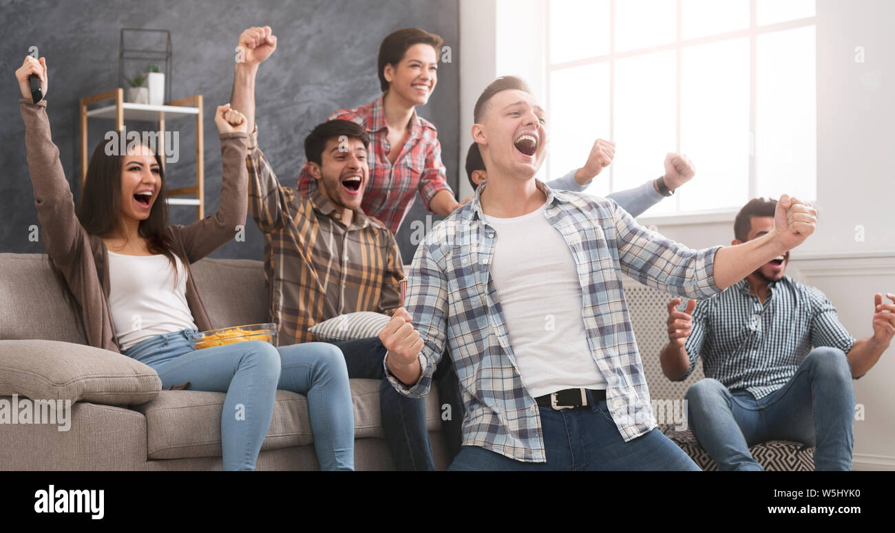 Excited friends having fun by watching football match at home Stock ...