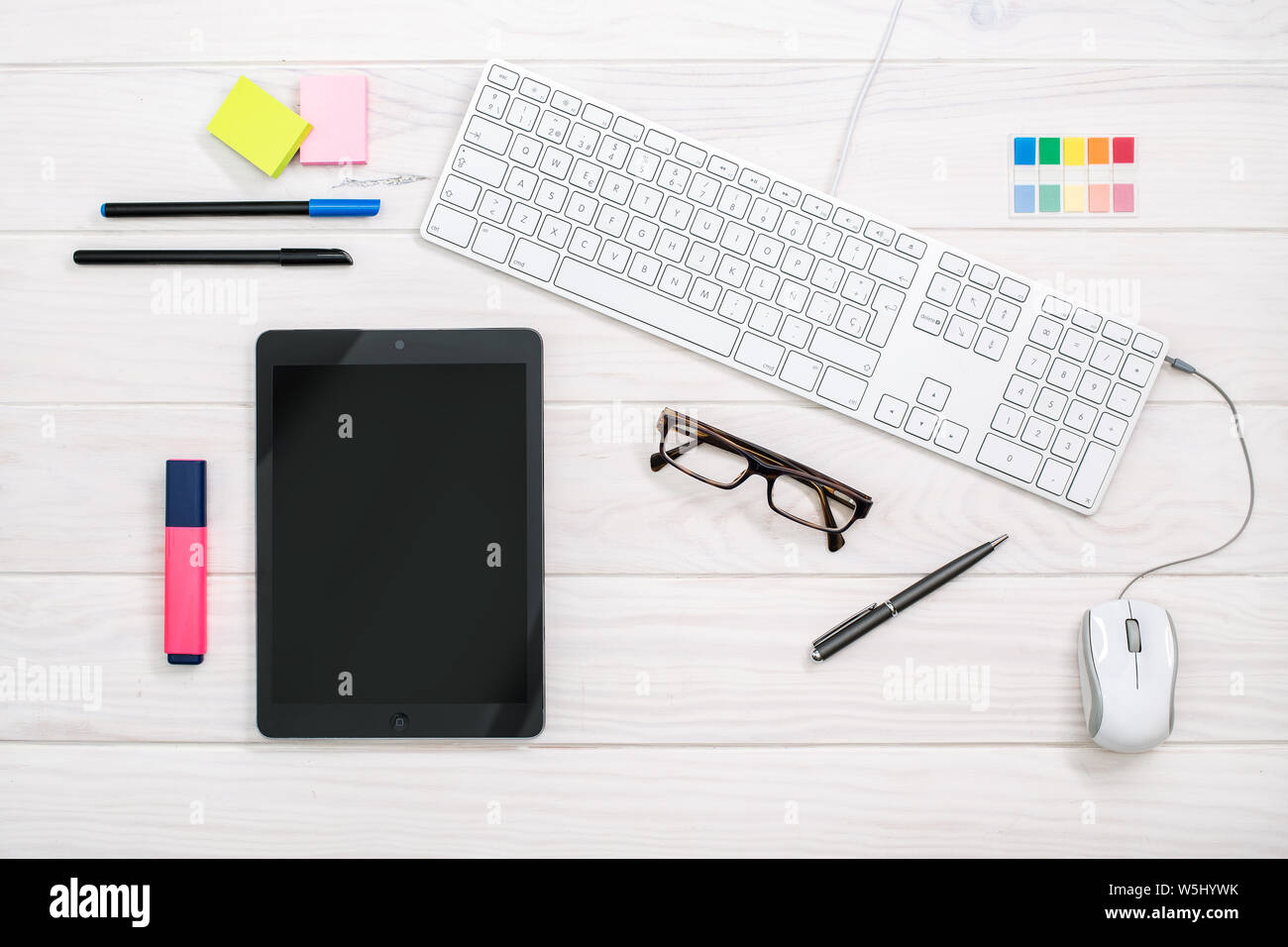 Workspace with keyboard, tablet and office supplies on white color ...
