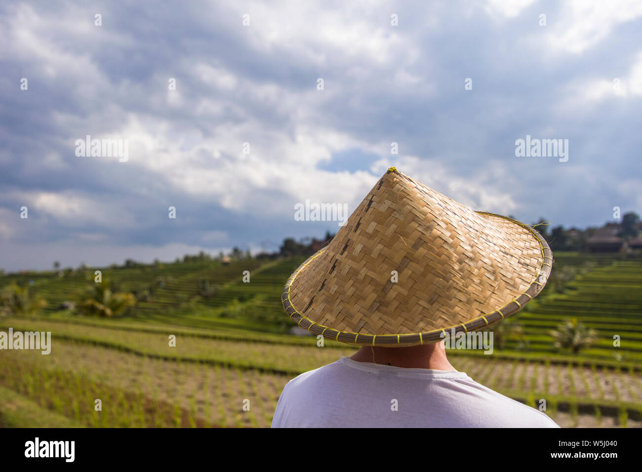 Man with traditional balinese cap at rice fields of Jatiluwih in ...