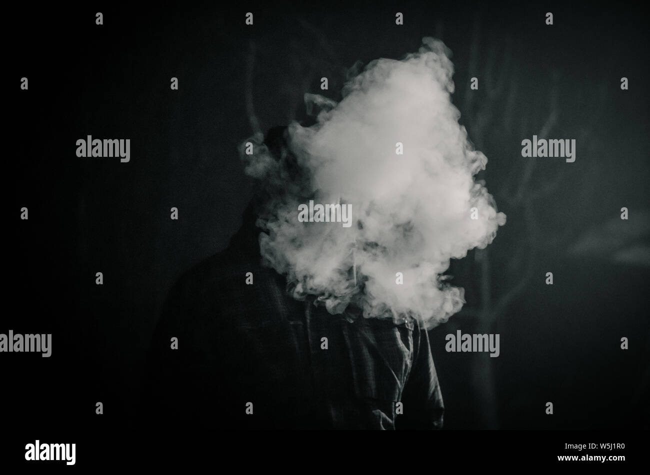 strange man smoking at night with big steam effect from the cigarette ...