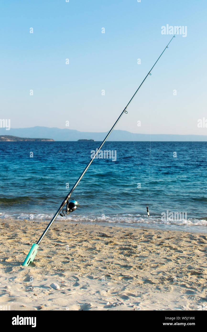 Fishing rod on beach shore Stock Photo - Alamy