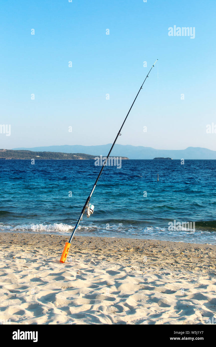 Fishing rod on beach shore Stock Photo - Alamy