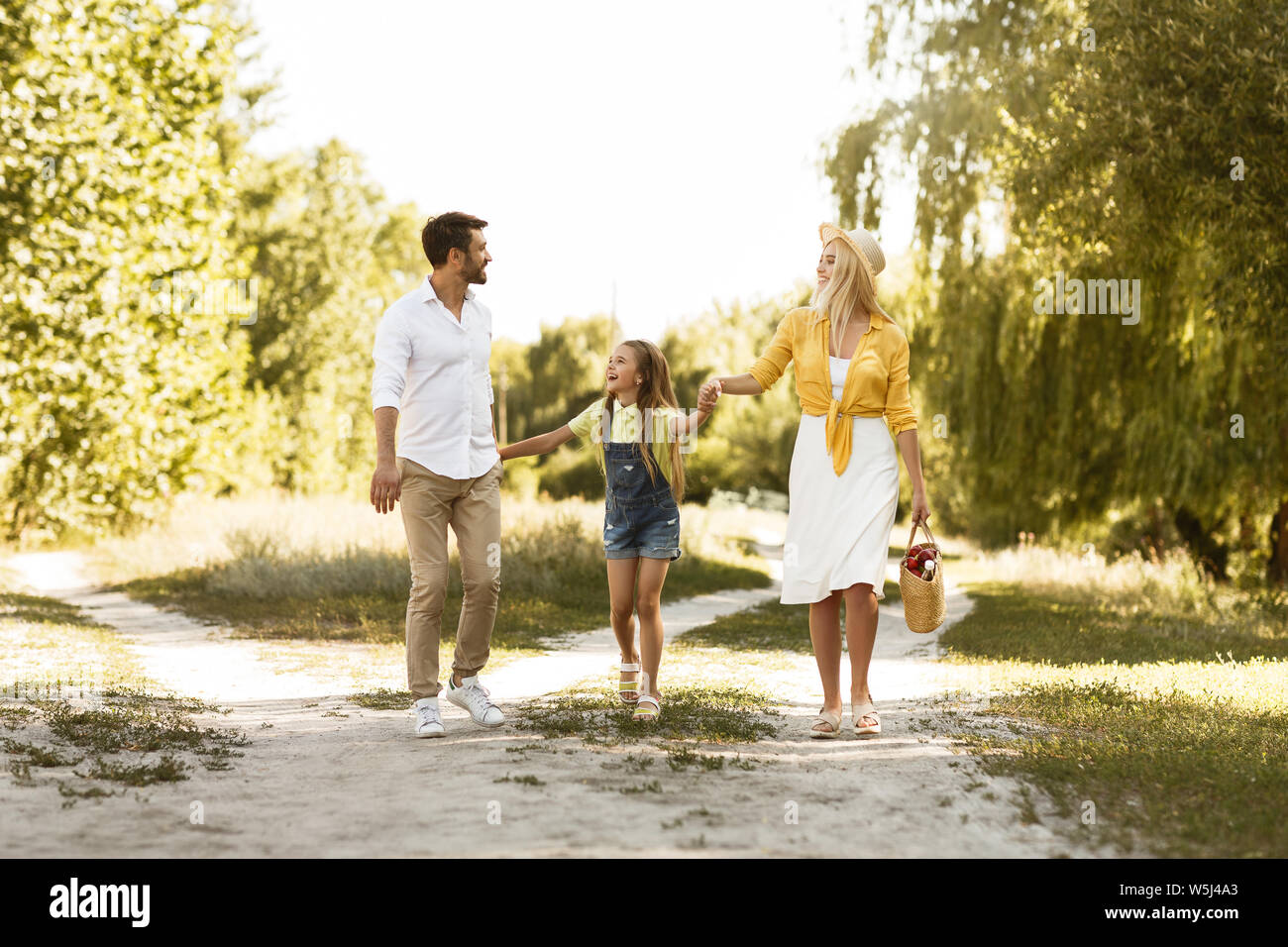Happy parents resting with child in countryside Stock Photo - Alamy