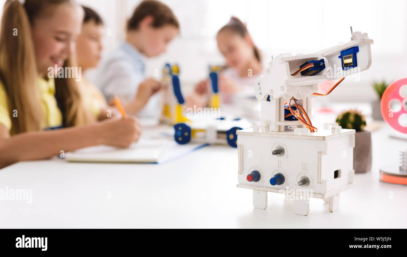 Children studying in class with robot at foreground Stock Photo - Alamy