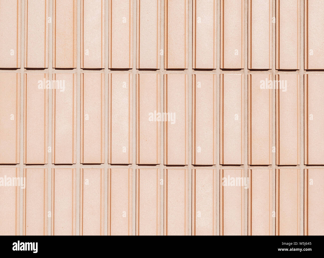 Orange rectangular tiles wall with rough surface as background Stock ...