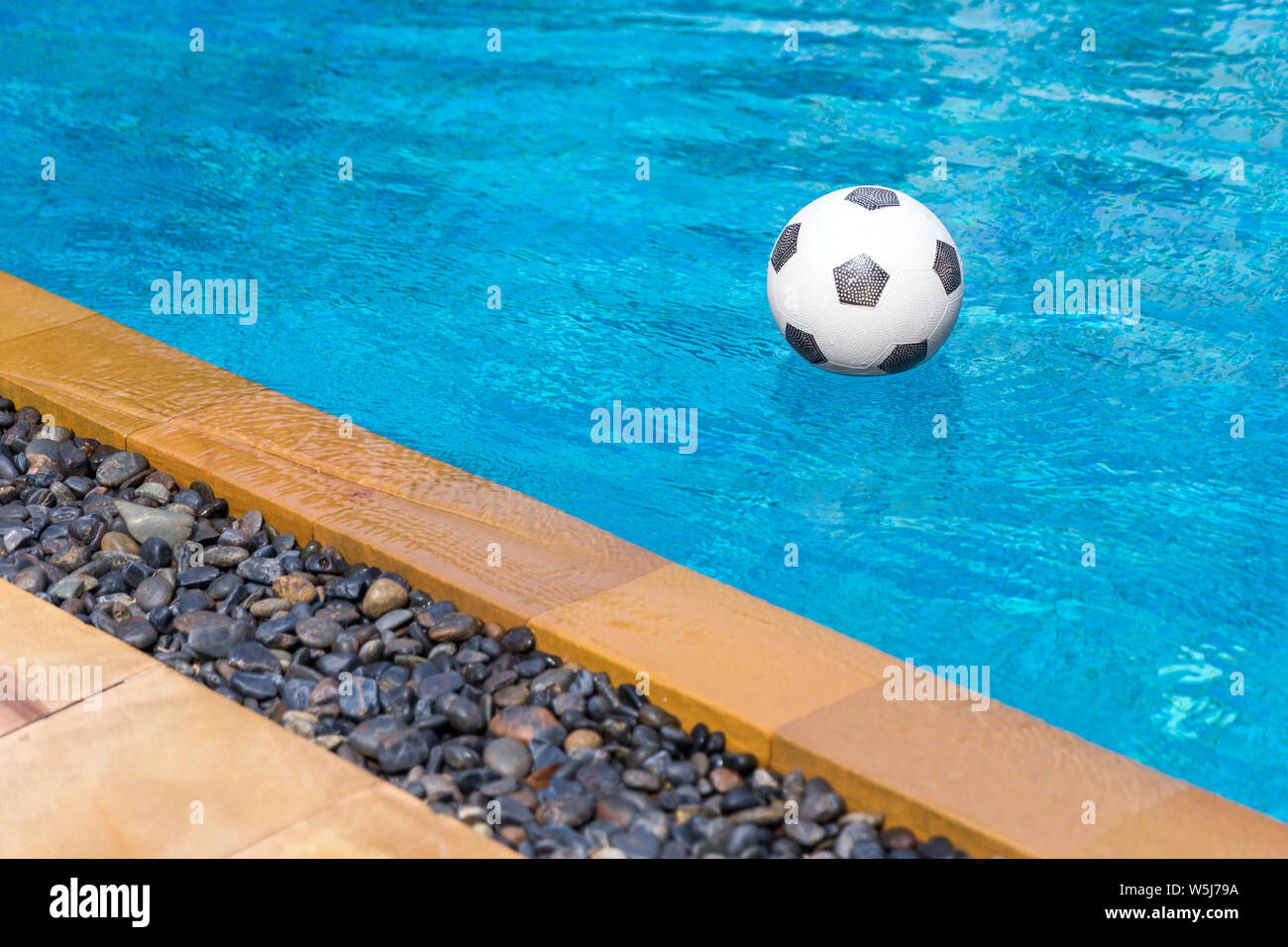 Soccer ball floating in the swimming pool Stock Photo - Alamy
