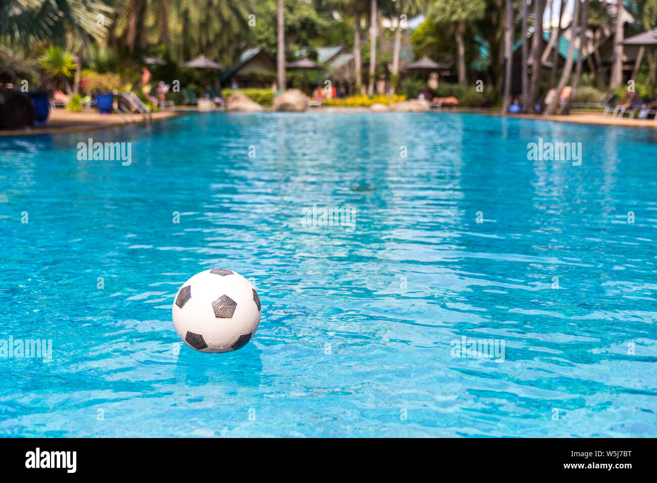Soccer ball floating in the swimming pool Stock Photo - Alamy