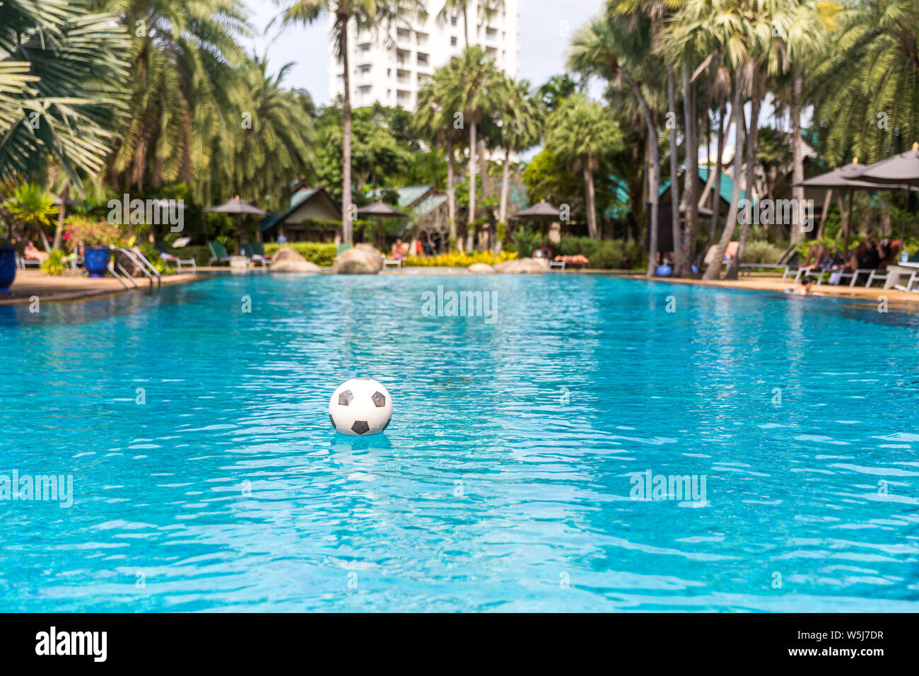 Soccer ball floating in the swimming pool Stock Photo - Alamy