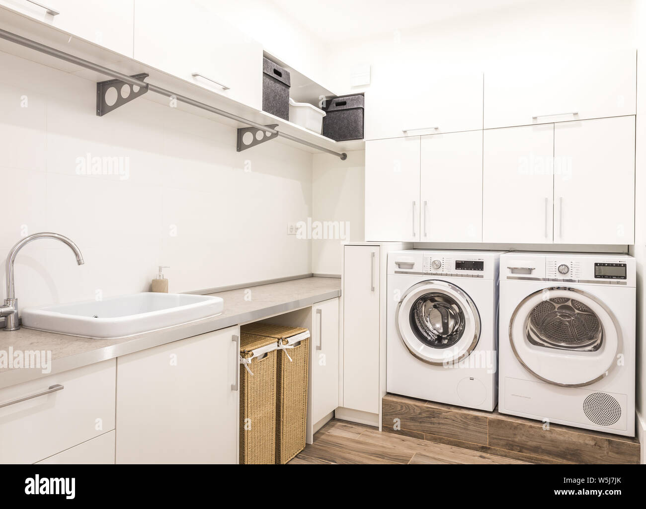 Laundry room with washing machine in modern house Stock Photo - Alamy