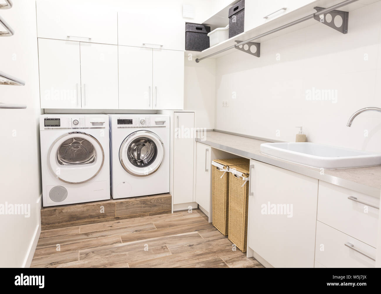 Laundry room with washing machine in modern house Stock Photo - Alamy