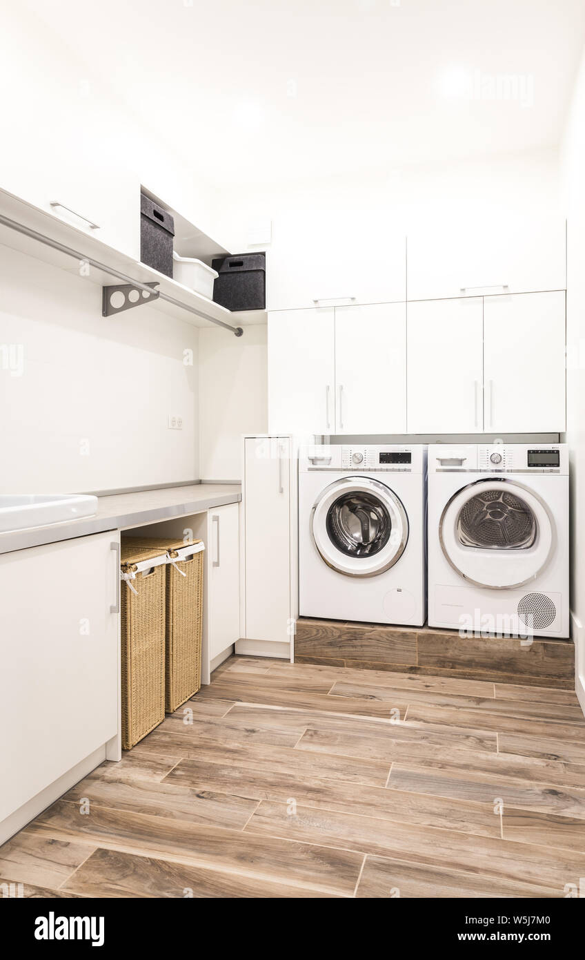 Laundry room with washing machine in modern house Stock Photo - Alamy