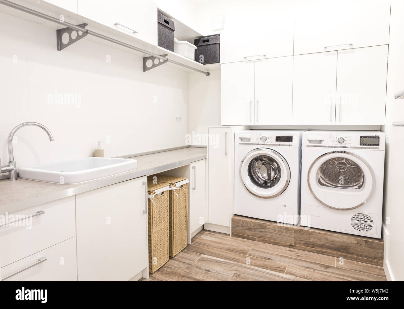 Laundry room with washing machine in modern house Stock Photo - Alamy