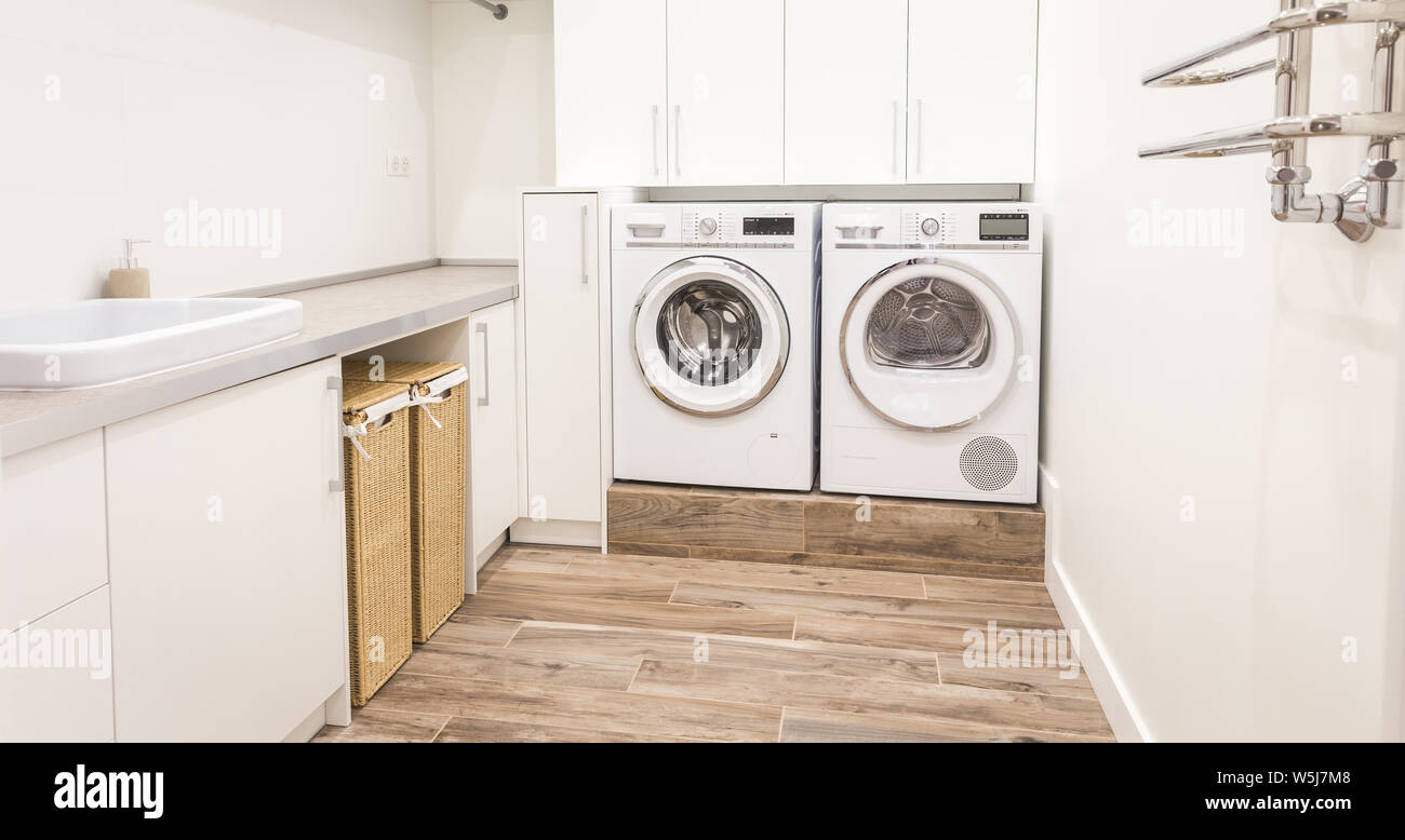 Laundry room with washing machine in modern house Stock Photo - Alamy
